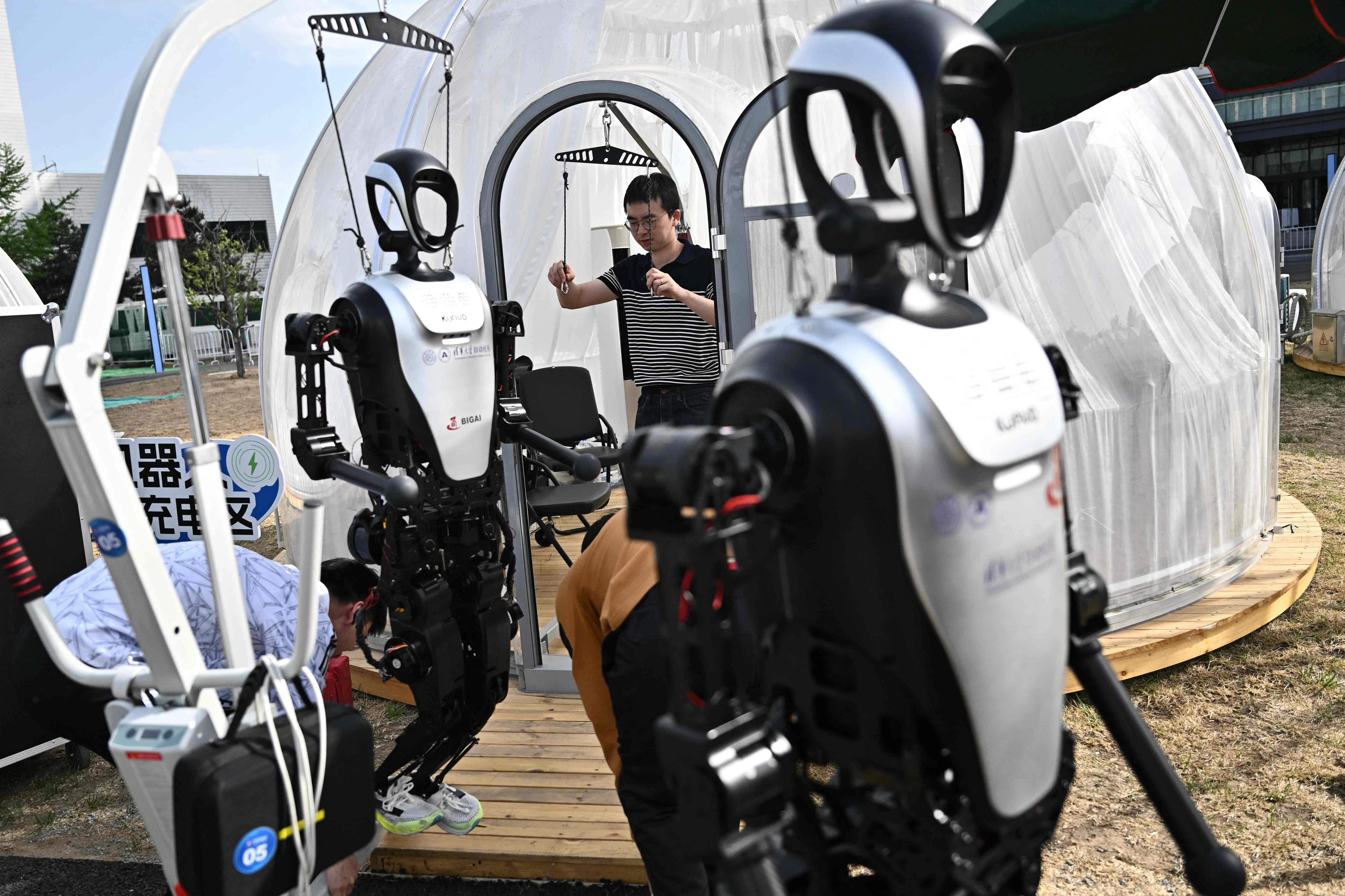 China pits humanoid robots against humans in half-marathon - The ...