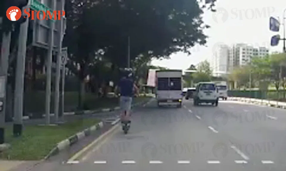 There's a bus, lorry and cars here -- but this e-scooter rider thinks he's king of the road | STOMP