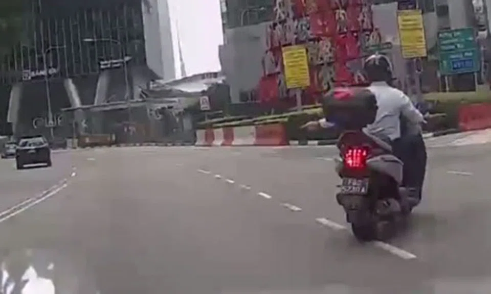 Biker recklessly cuts across traffic, then points at driver as if he ...