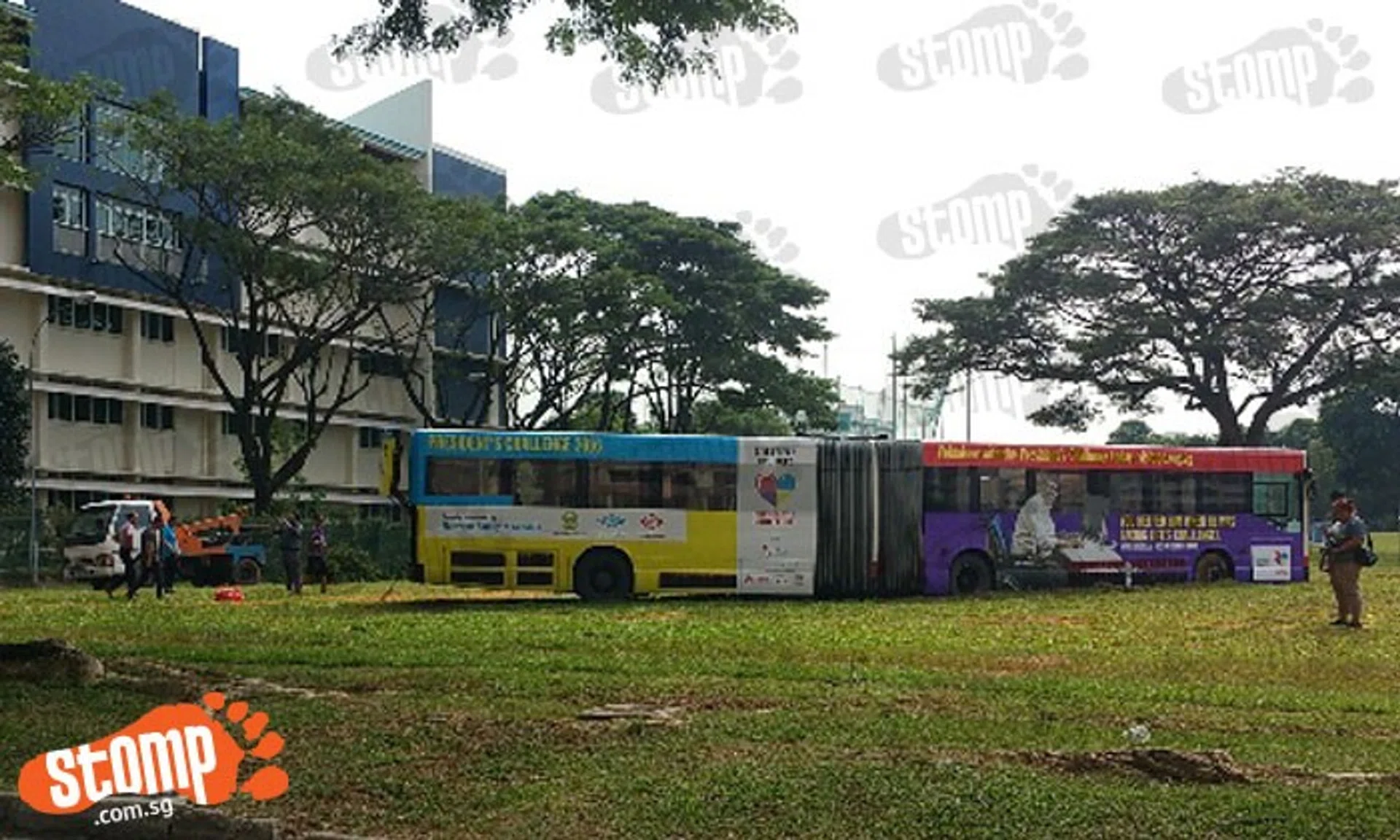 How on earth did it end up there? SMRT bendy bus gets stuck on field at ...