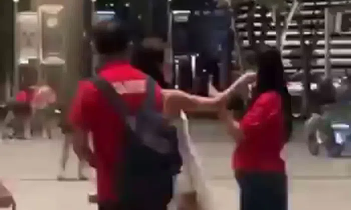 Woman pulls down safe distance ambassador's mask at Marina Bay Sands ...