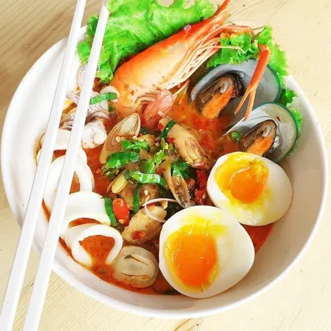Macho owner and hunky stall assistants are as hot as the tom yum they ...