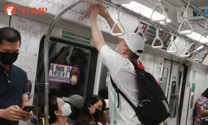 Commuters puzzled by man removing stickers from MRT map on train | STOMP