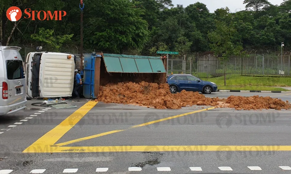 Tipper truck spills soil on road after overturning at Woodlands ...