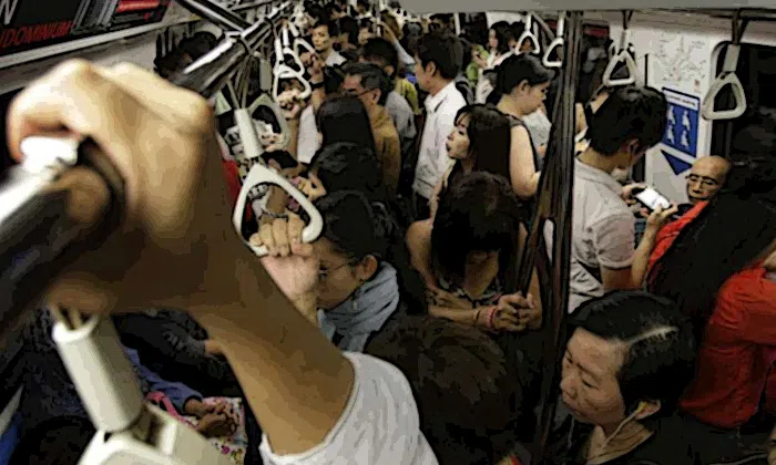 Female passenger distracted by phone on train doesn't notice man ...