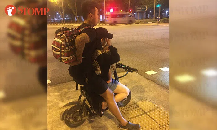 Man rides PMD across road in Sengkang -- with baby and woman | STOMP