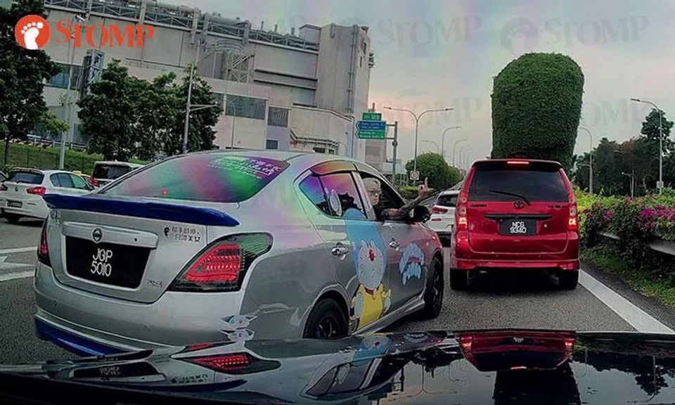 Doraemon decal, bad attitude: Driver flashes middle finger while ...