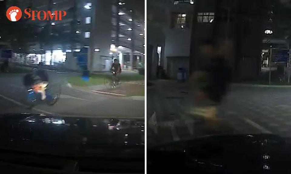 Cyclist flashes middle finger at driver while speeding across road in ...