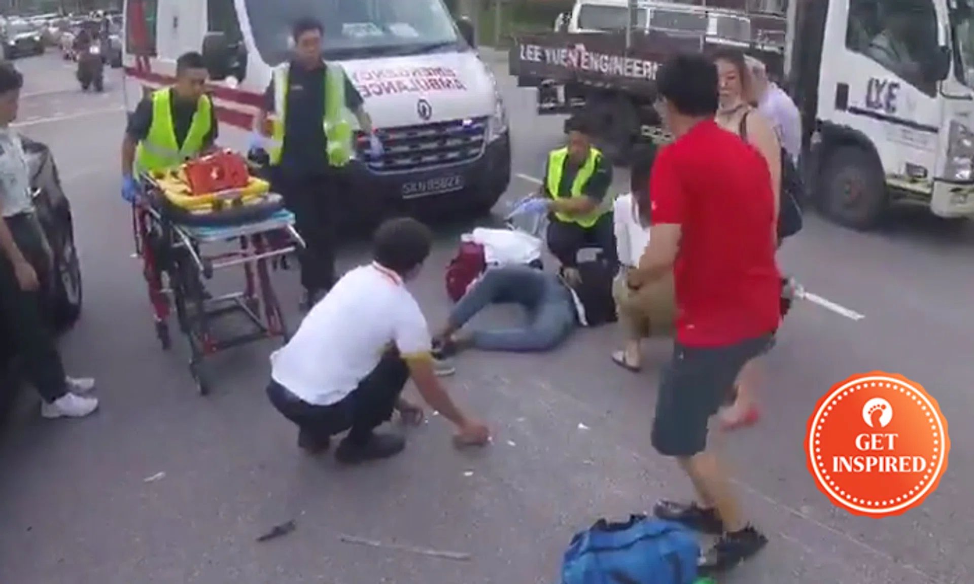 Biker and passers-by stop to help motorcyclist lying injured on the ...
