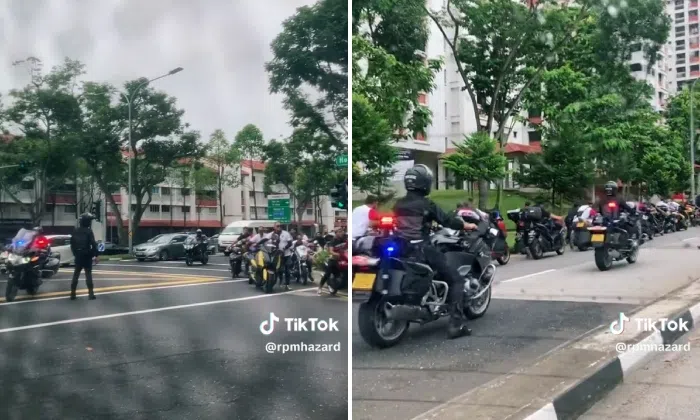 More than 20 riders push their motorcycles along road escorted by ...
