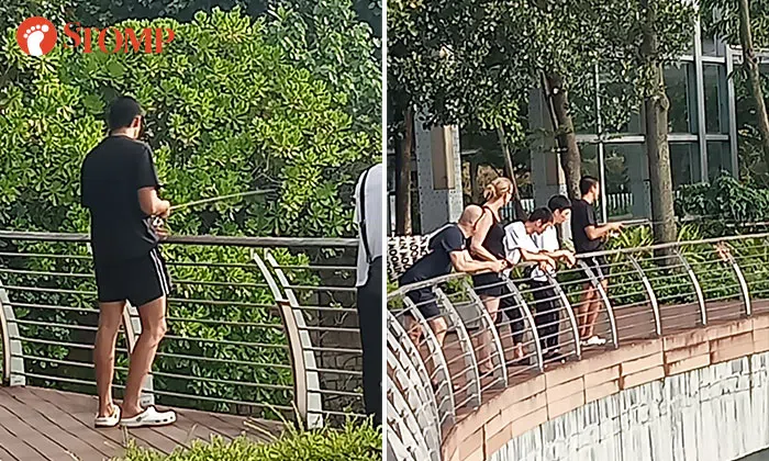 Man fishes along Sentosa Boardwalk even though it is strictly ...