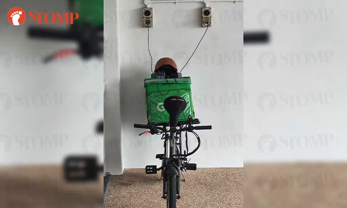 GrabFood rider charges e-bike at Chinatown HDB block despite it being ...