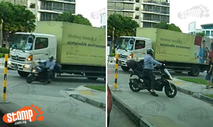 Biker gestures angrily after almost colliding with lorry driver at ...