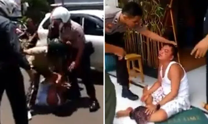 Policeman in Indonesia gangs up with mob and beats up reckless driver ...