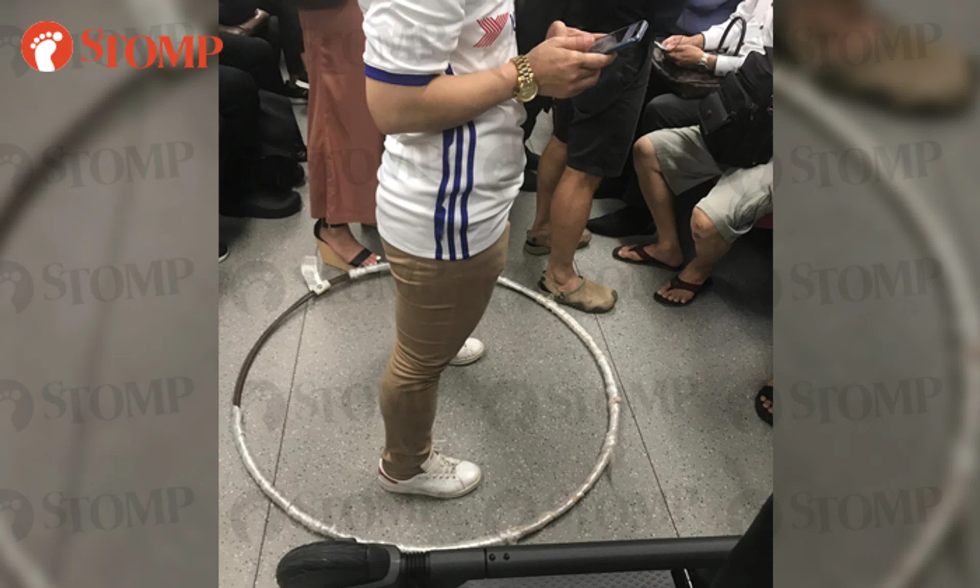 Woman creates her own personal space on train -- with a hula hoop | STOMP