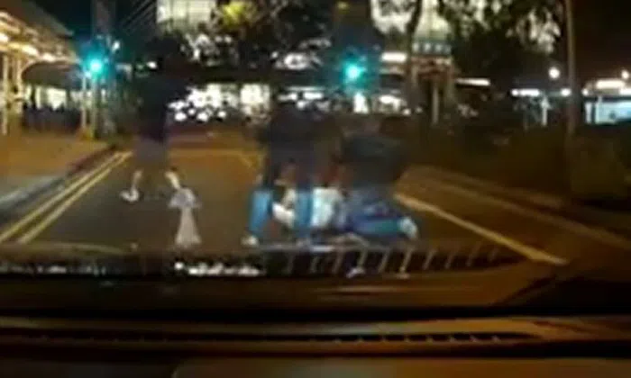 Group of men chase and pin down man in the middle of road at Tampines ...