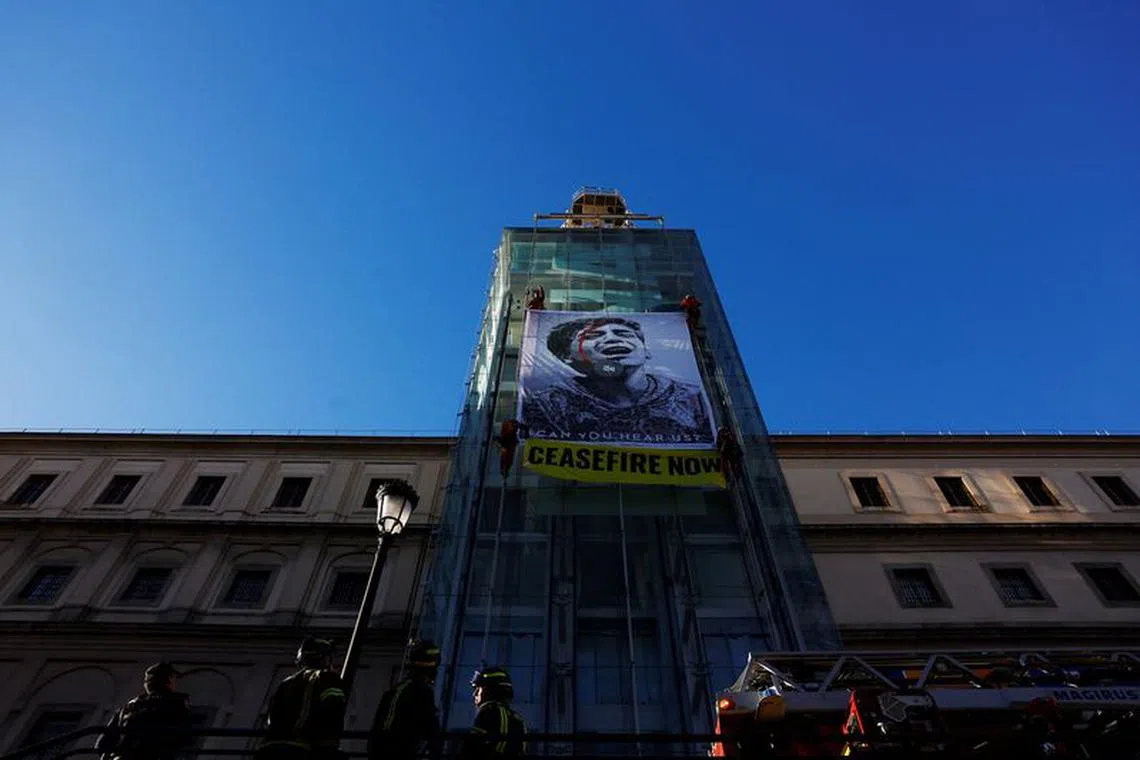 Activists unfurl banner at Madrid museum to demand Gaza ceasefire | The ...