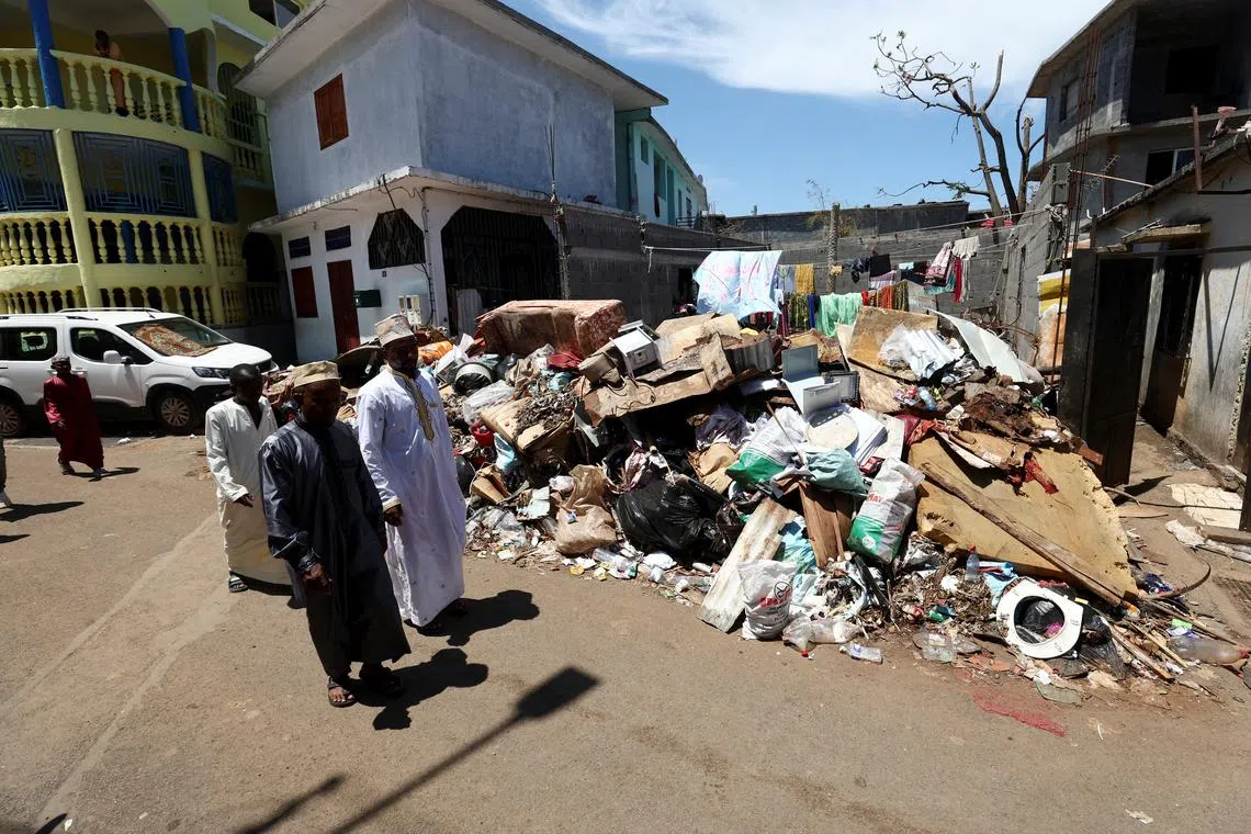 Angry residents of cyclone-hit Mayotte jeer Macron, plead for water ...