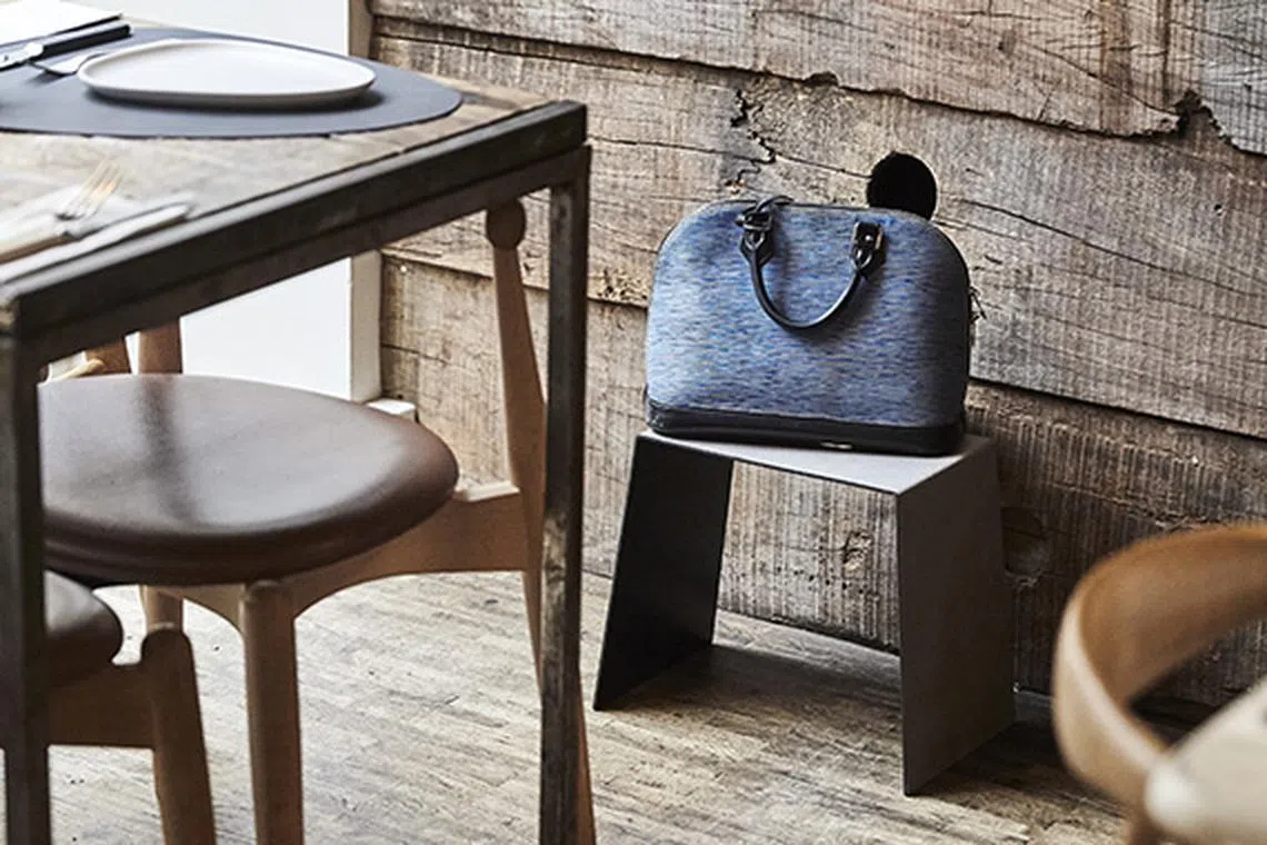 More restaurants are adding tiny purse stools for big luxury handbags ...