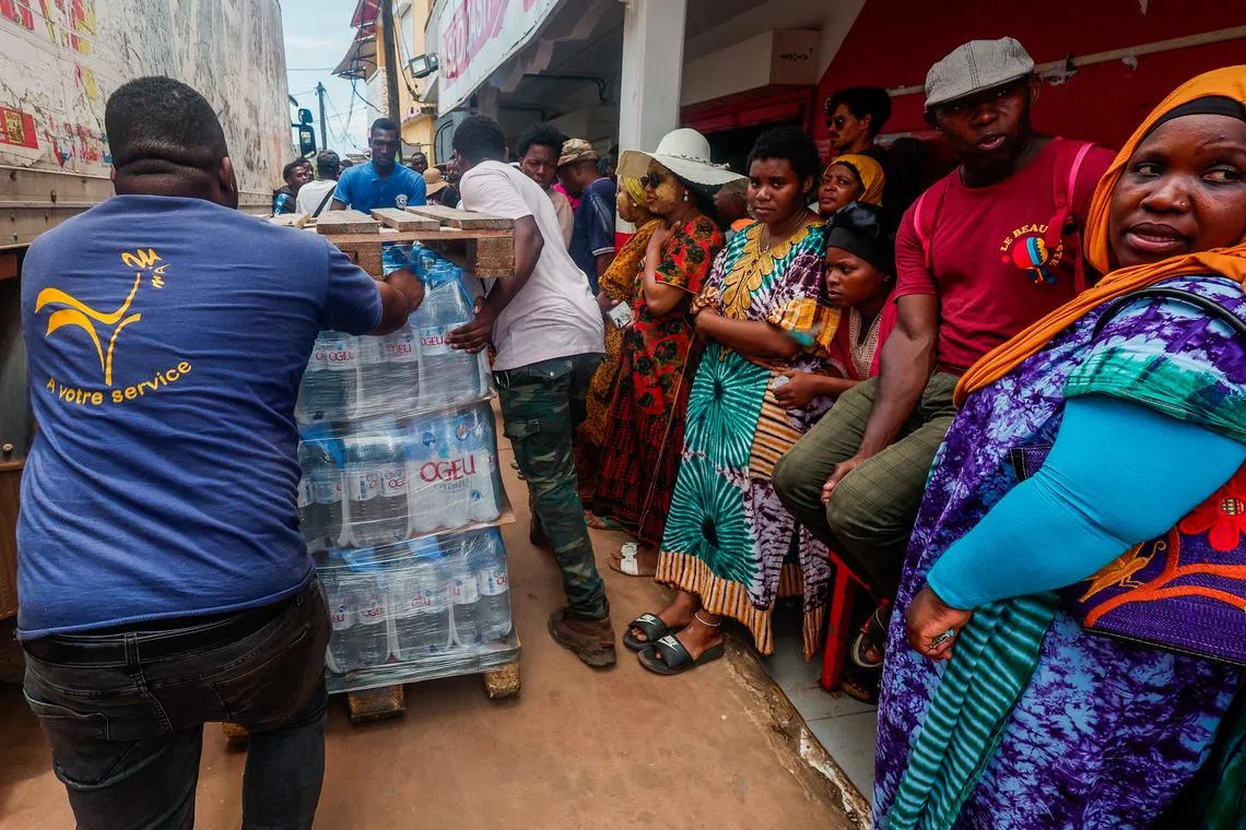 Angry residents of cyclone-hit Mayotte jeer Macron, plead for water ...