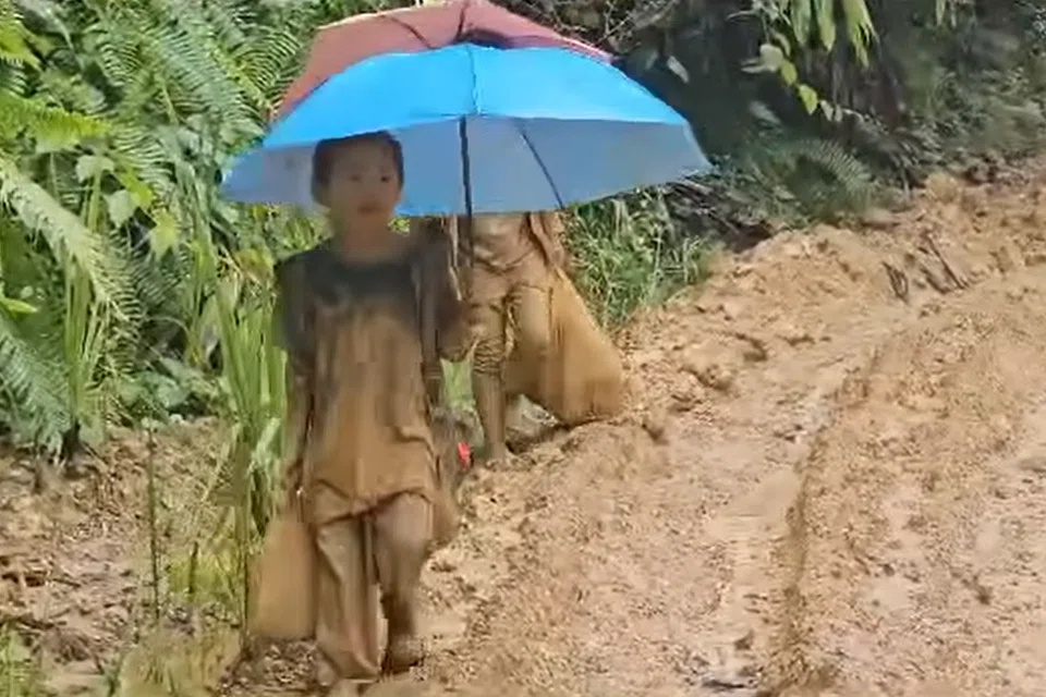 Sabah pupils, teachers walk for two days on rain-soaked mud track to ...
