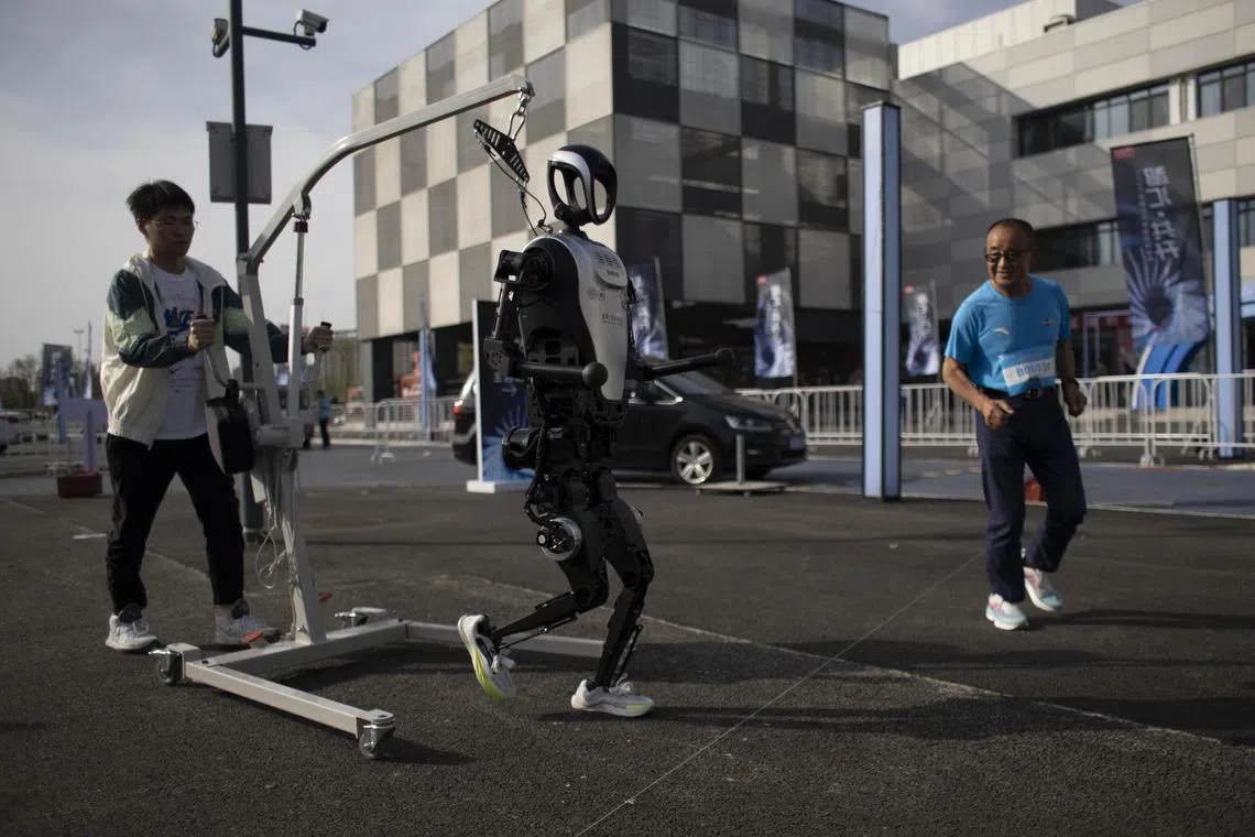 China pits humanoid robots against humans in half-marathon | The ...