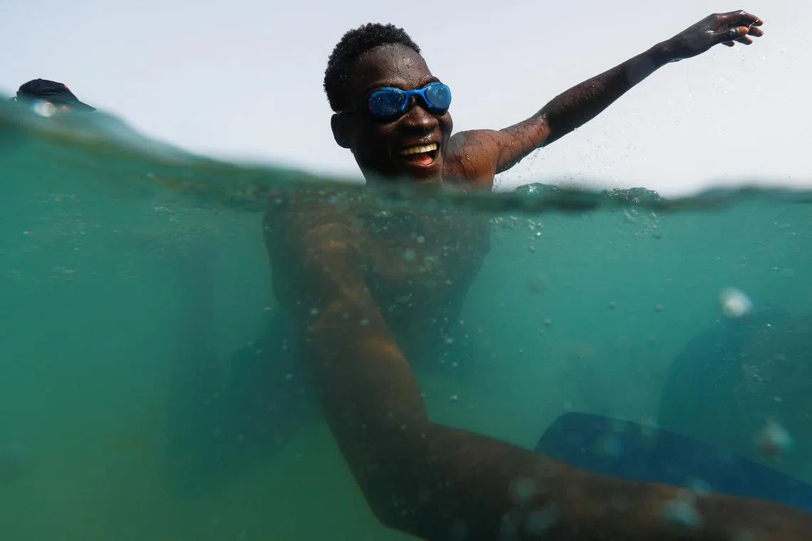 Volunteers help migrants reverse water trauma in Spain's Canaries | The ...