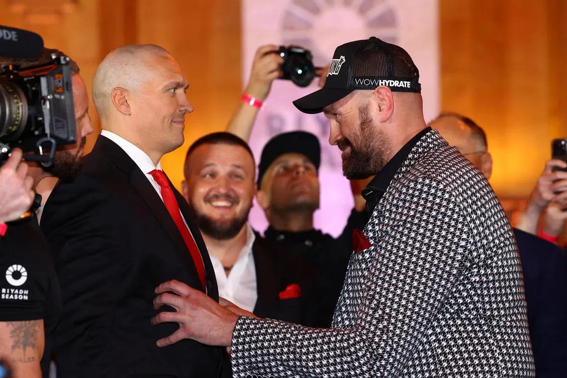 Tyson Fury signs photo of Oleksandr Usyk punching him in head, hands it ...