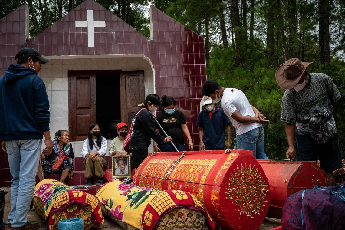 Indonesian villagers on Sulawesi dress corpses in ritual for the dead ...