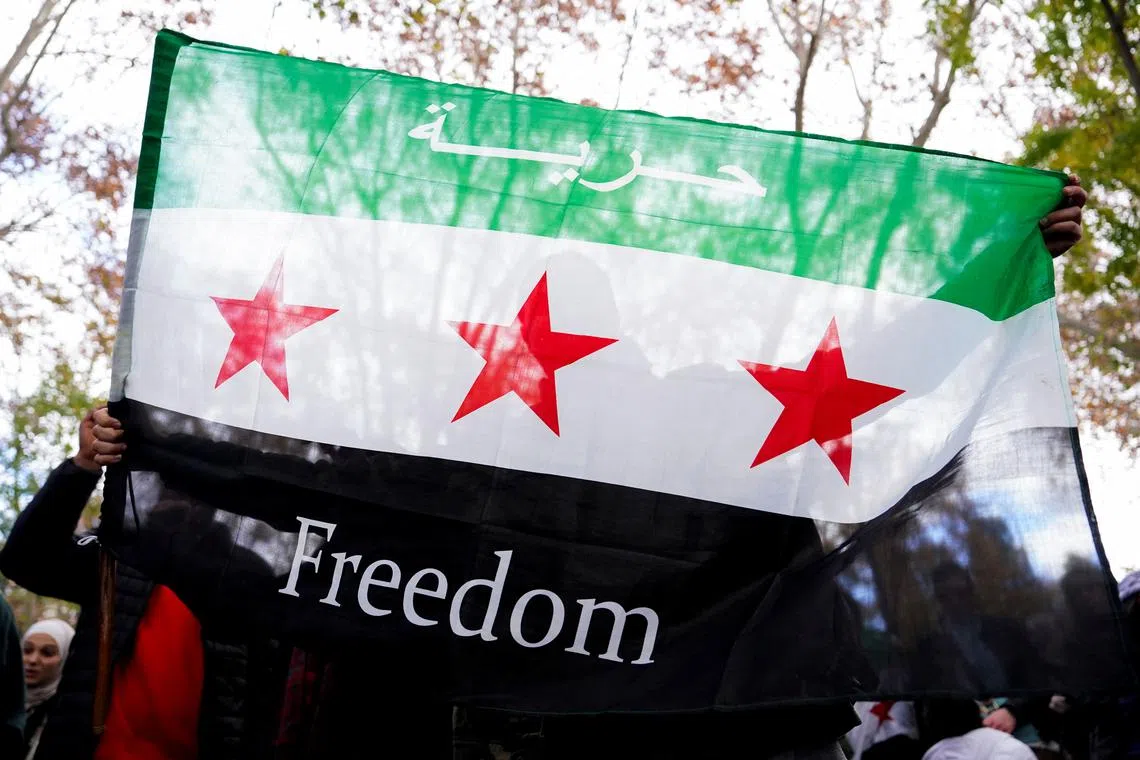 Syrian rebel supporters hoist flags at embassies abroad | The Straits Times