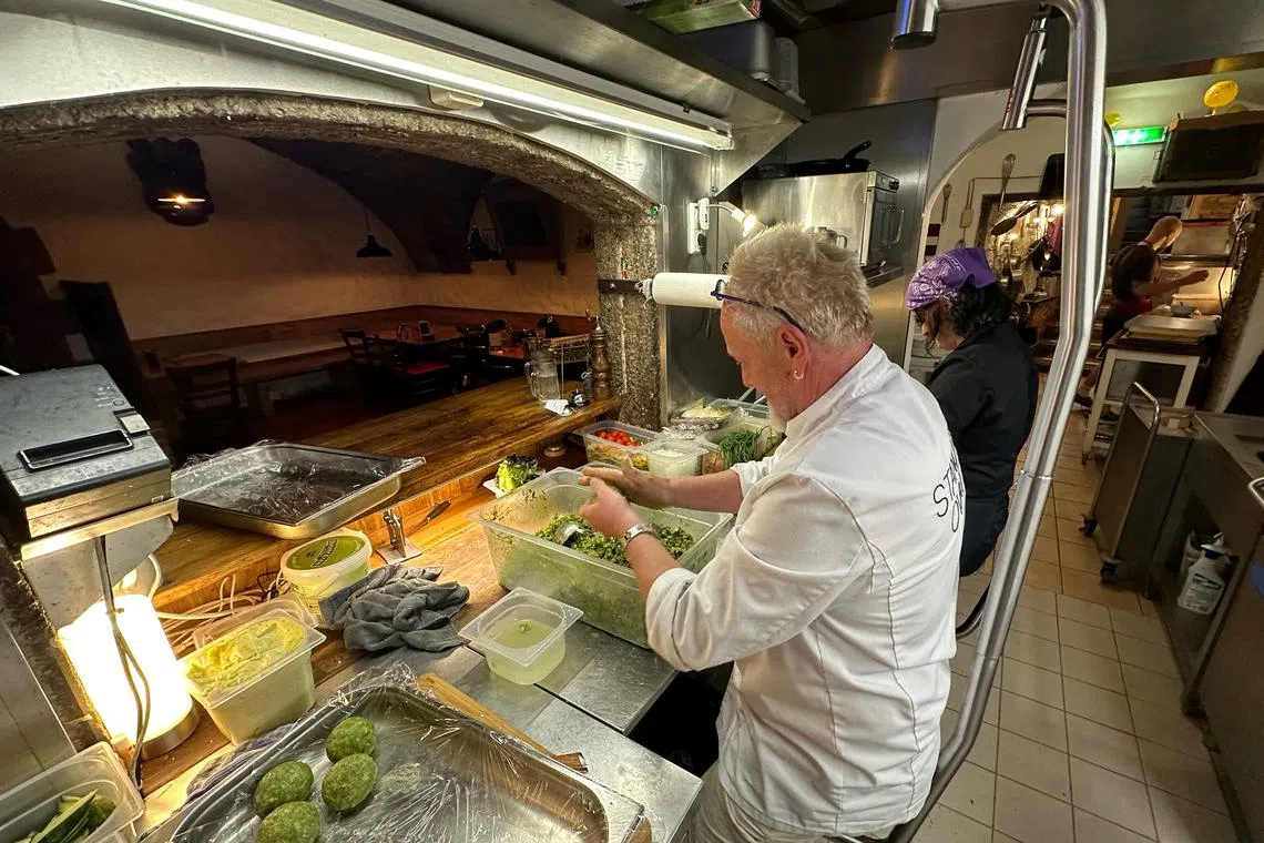 Austrian chef defies injury with floating kitchen seat | The Straits Times