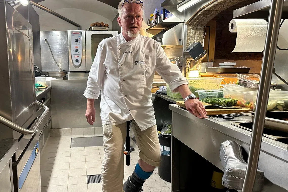 Austrian chef defies injury with floating kitchen seat | The Straits Times