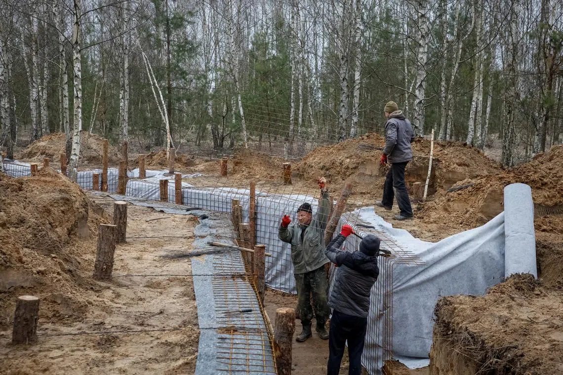 Ukrainian soldiers, engineers toil round the clock to build defences ...
