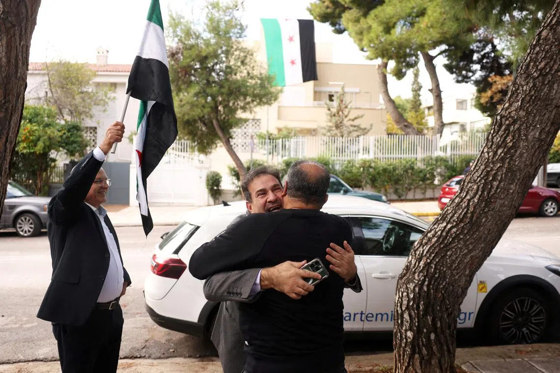 Syrian rebel supporters hoist flags at embassies abroad | The Straits Times