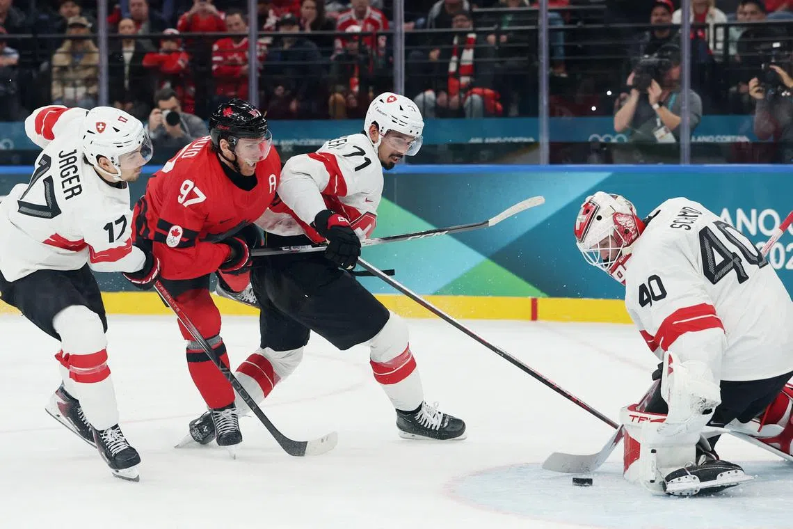 Ice hockey-Canada ease past Swiss, Finland beat Sweden, Slovakia ...