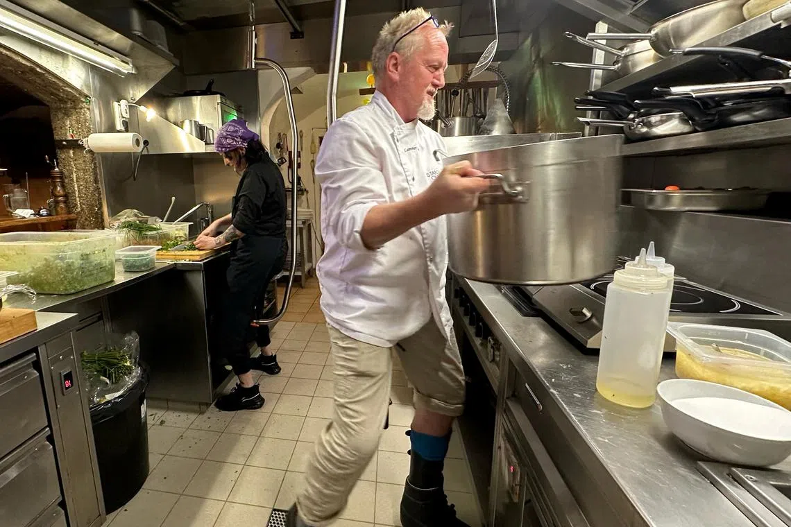 Austrian chef defies injury with floating kitchen seat | The Straits Times