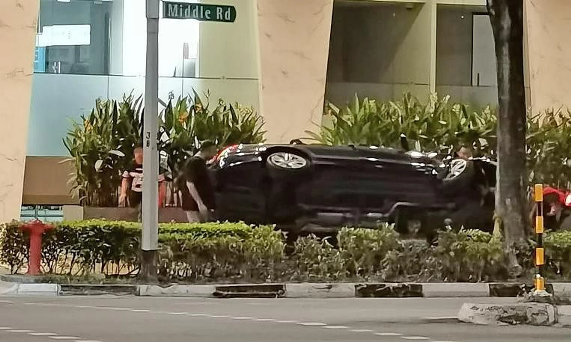 Car flips on side after crashing into tree near Middle Road | The New Paper